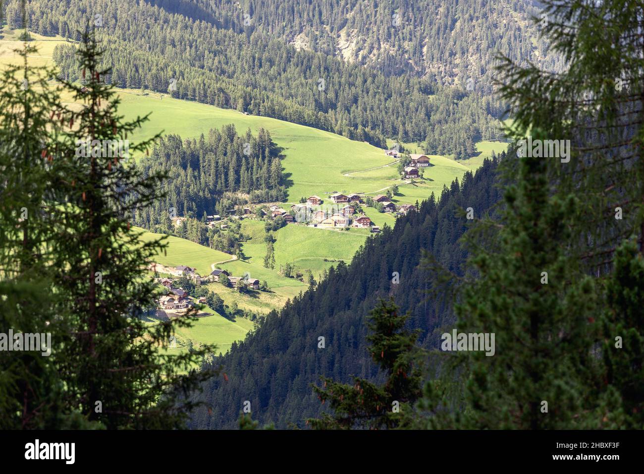 View of an alpine village on the slope of the Dolomites, Italian Alps ...