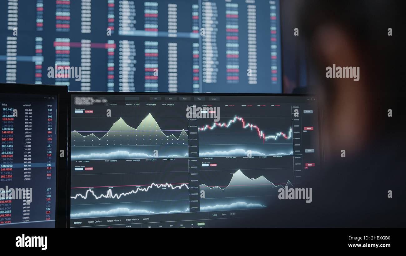 Extreme close-up young adult man, crypto stock chart monitor background ...