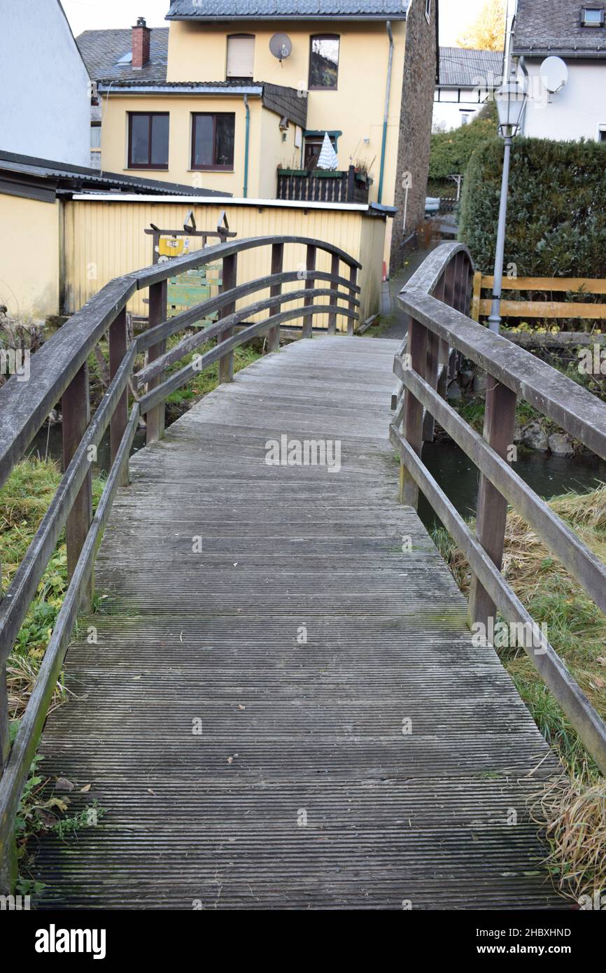 wooden bridge across a tiny river Stock Photo - Alamy