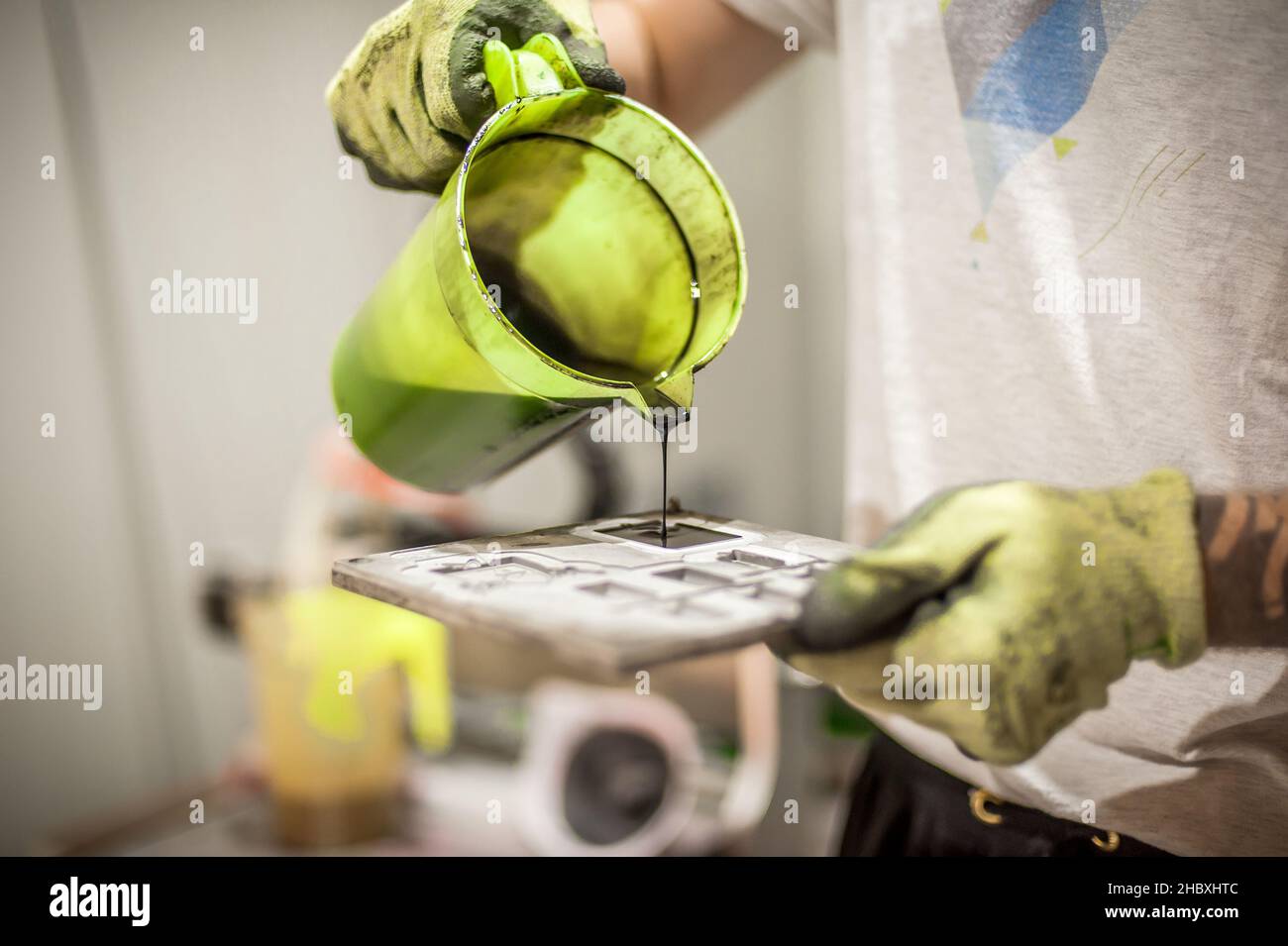Professional worker technician work with soft PVC liquid rubber in mold ...