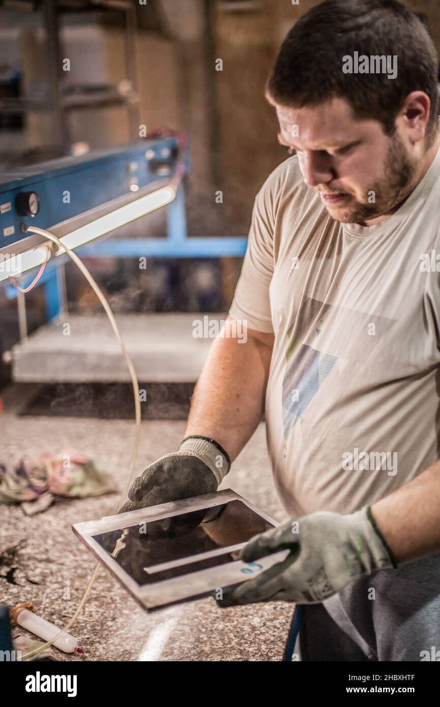 Professional worker technician work with soft PVC liquid rubber in mold ...