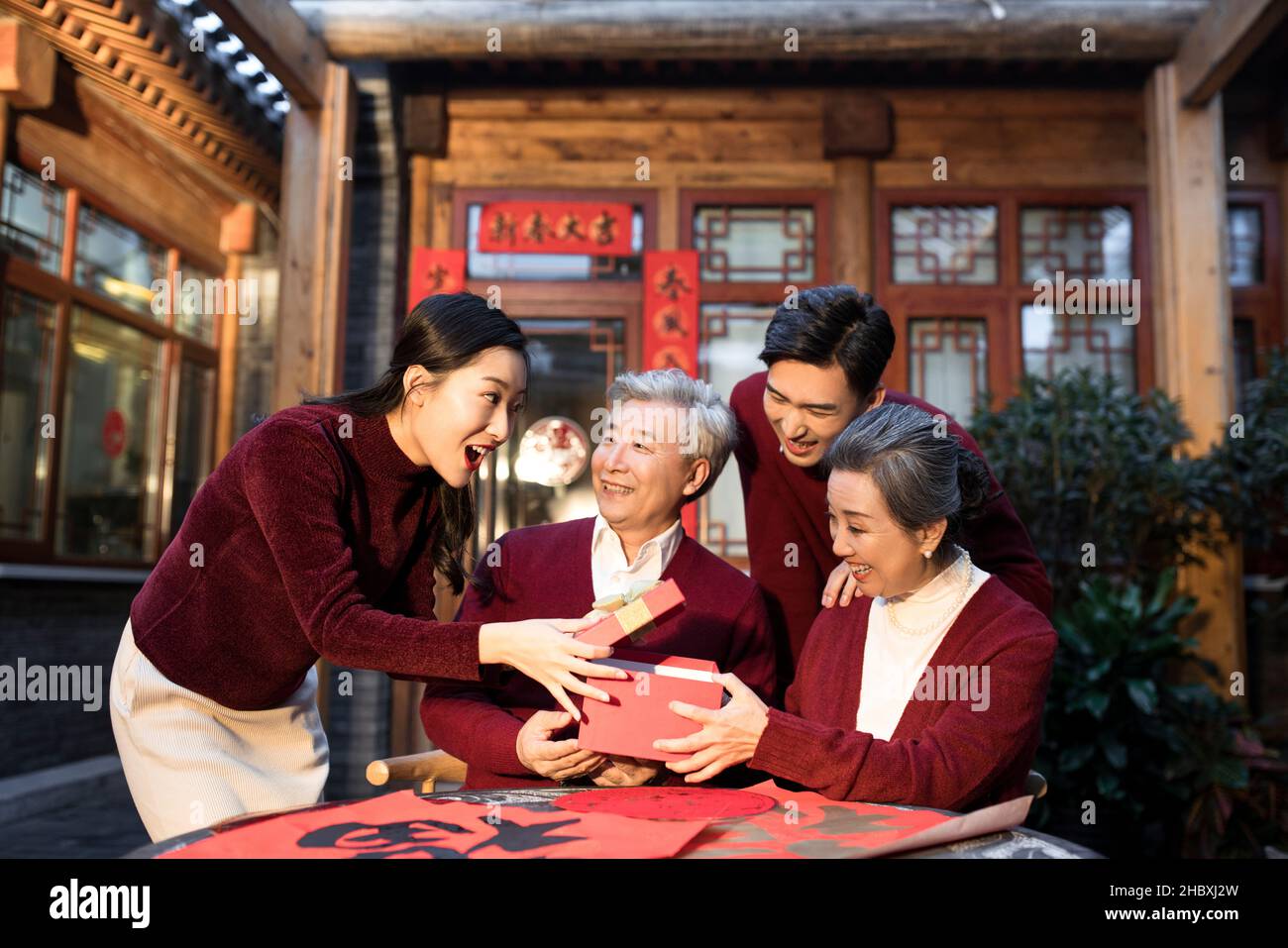 Children giving their parents New Year gifts Stock Photo - Alamy