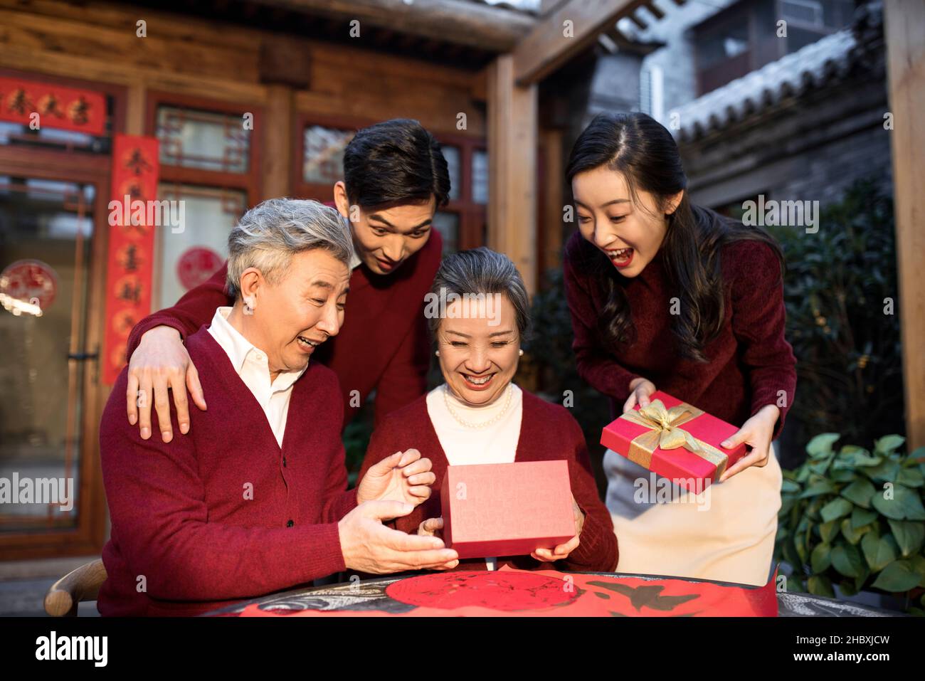 Children giving their parents New Year gifts Stock Photo - Alamy