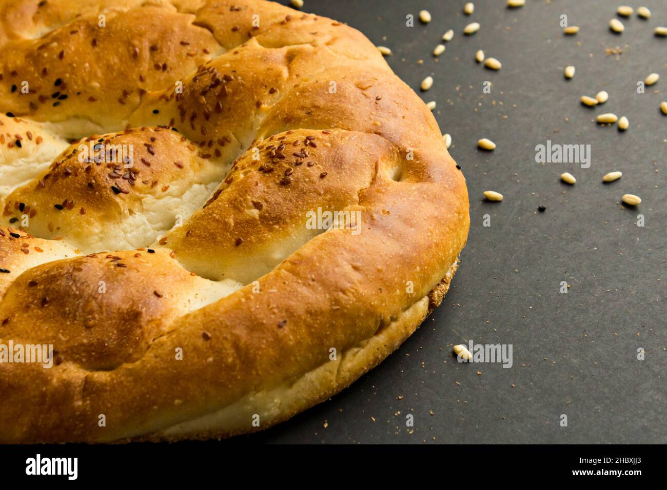Traditional Turkish,Fresh,Circular Ramadan Bread,Pide on black surface ...