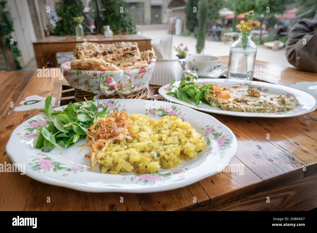 Two plates of traditional Iranian food on the wooden table of ...