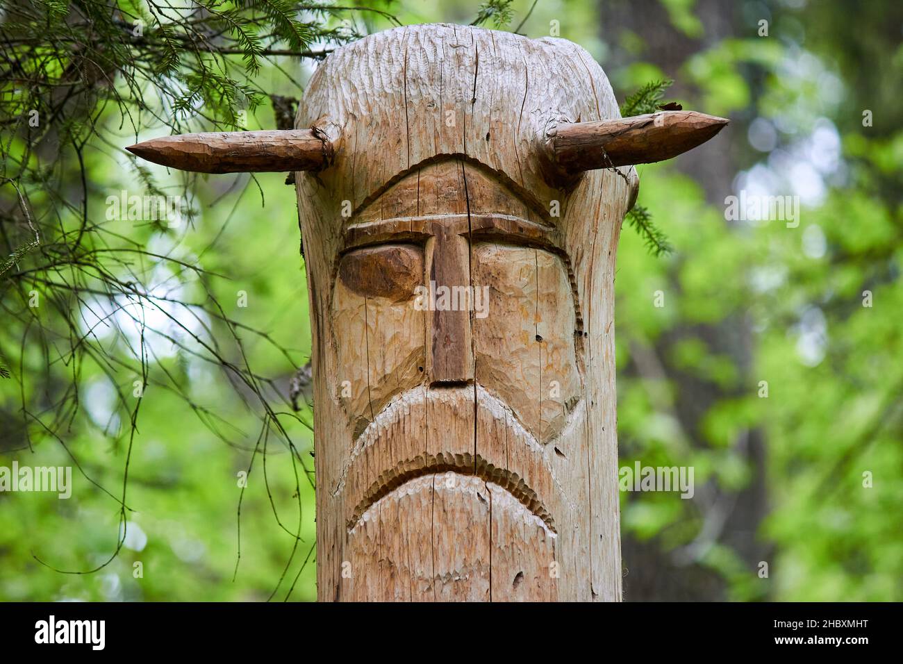 The image of the Slavic deity Veles carved from a tree trunk on a neo ...