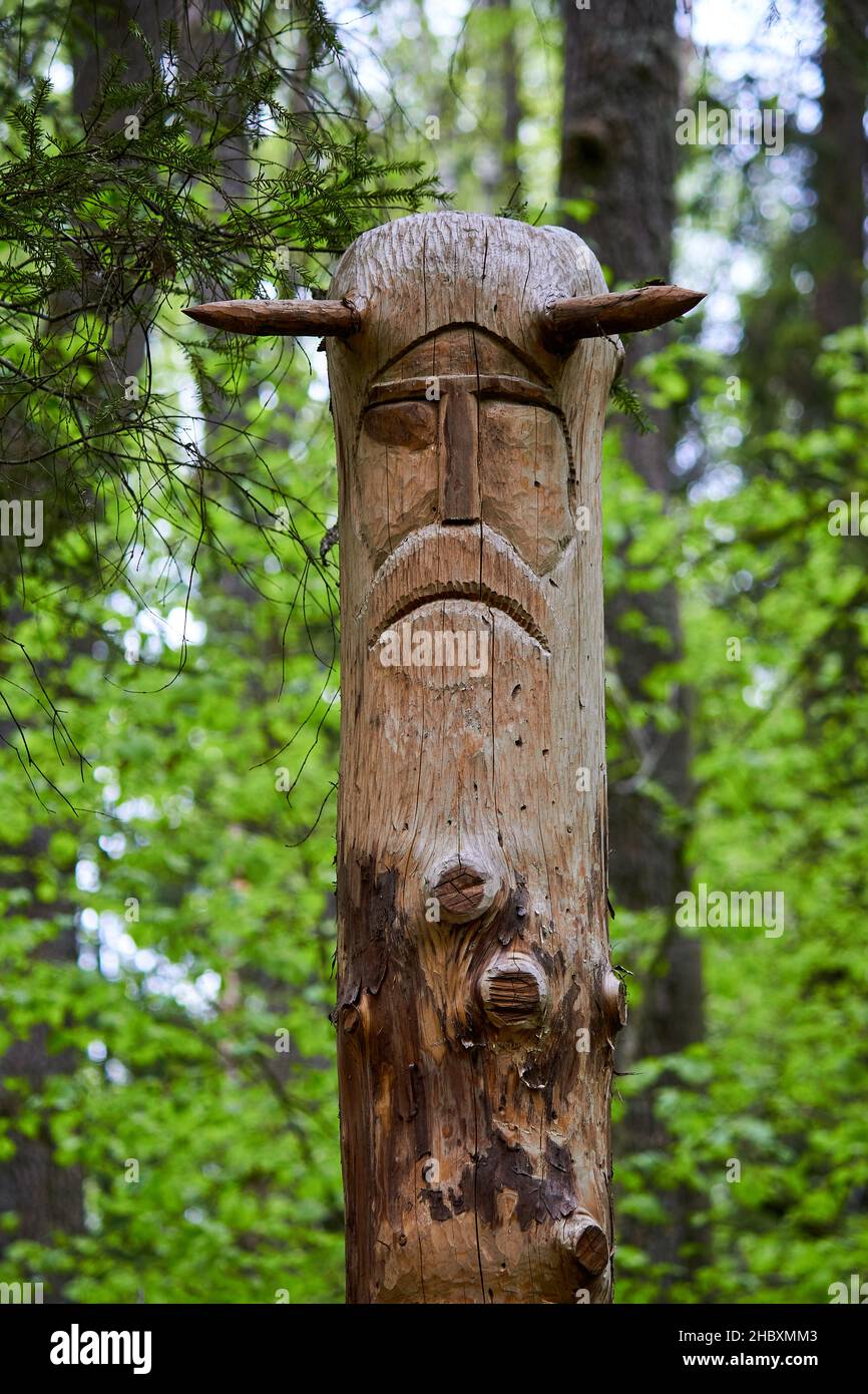 The image of the Slavic deity Veles carved from a tree trunk on a neo ...