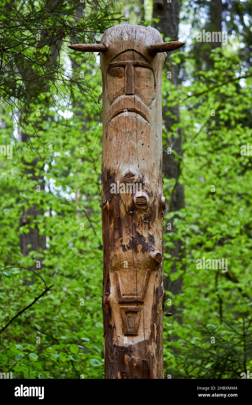 The image of the Slavic deity Veles carved from a tree trunk on a neo ...