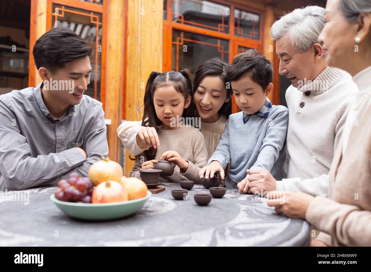 Happy families drinking tea and chatting in the courtyard Stock Photo ...