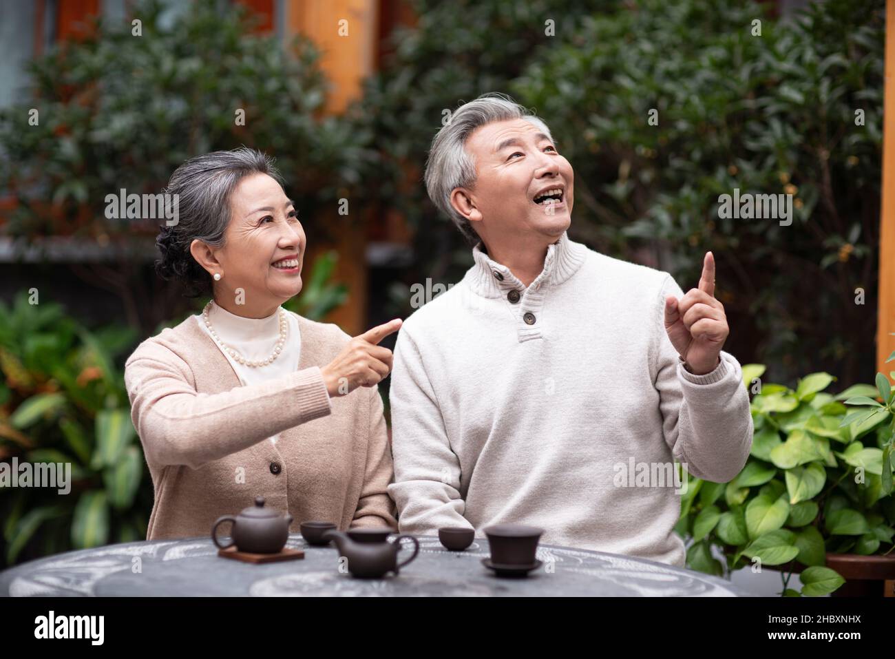 Old couple drinking tea and chatting in the courtyard Stock Photo - Alamy
