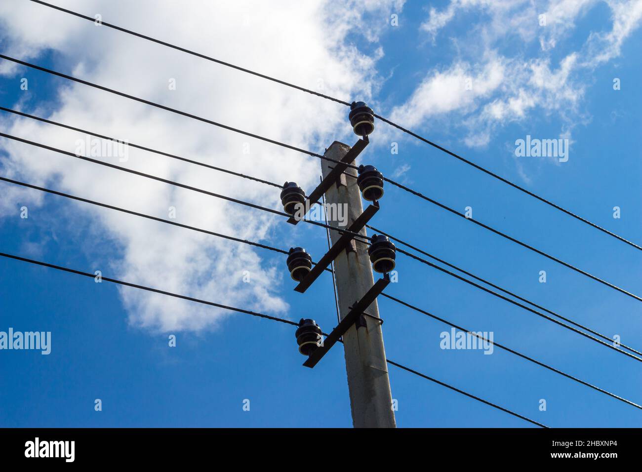 Pole with insulators and power line Stock Photo - Alamy