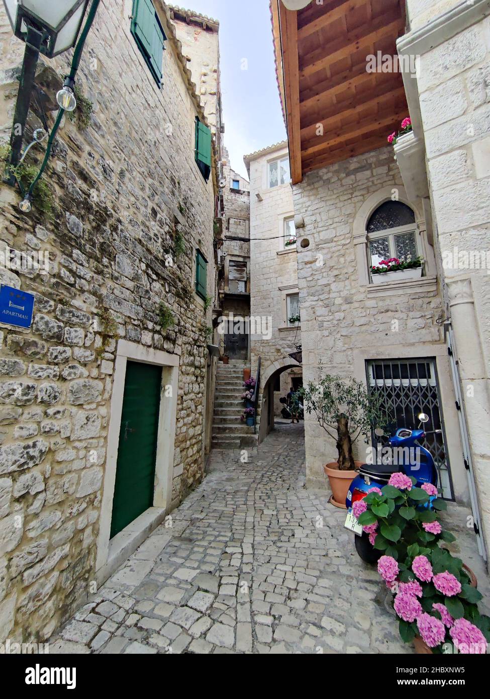 Streets of historic and tourist town of Hvar with fort, port and yacht ...