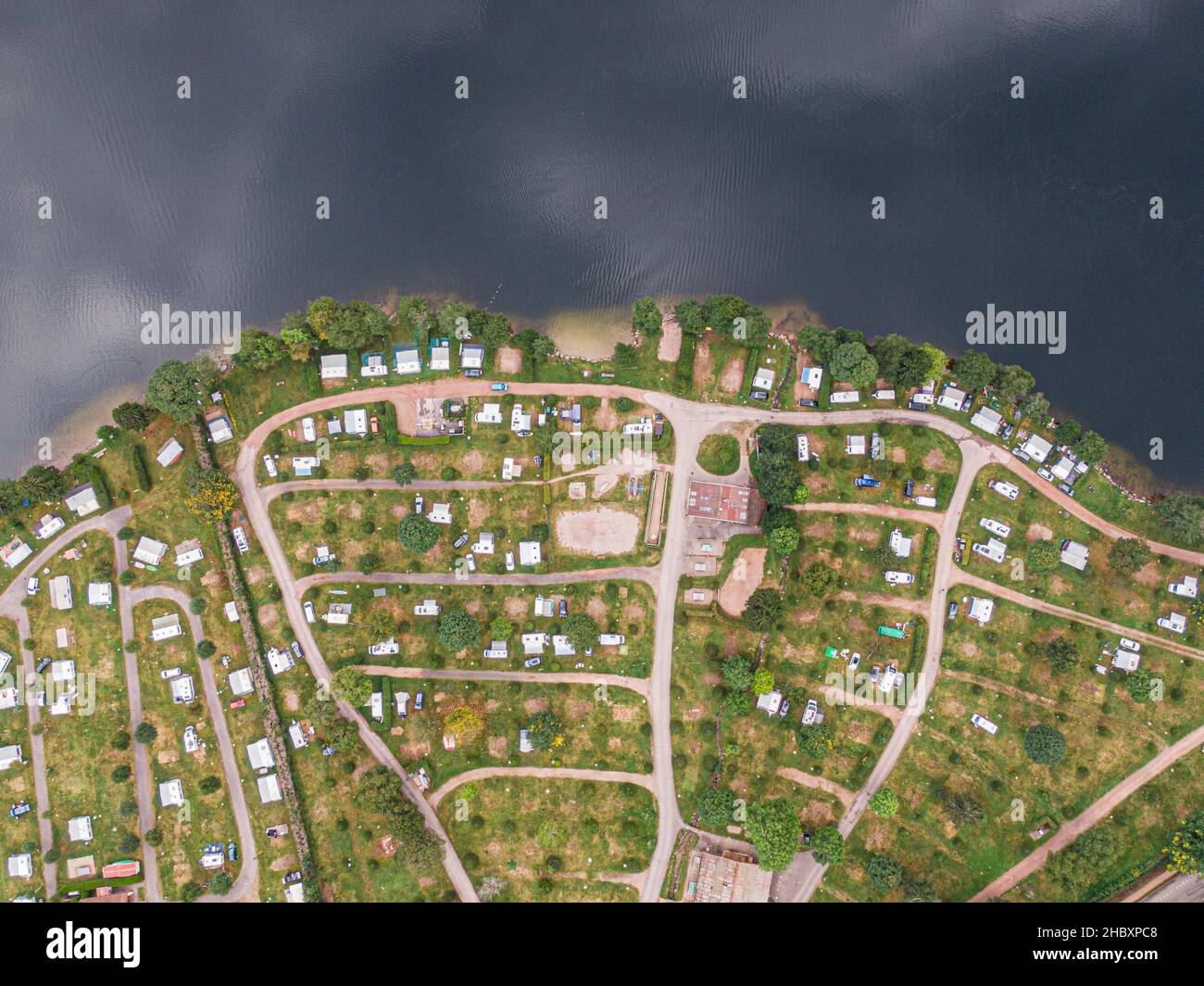 Aerial view of Longemer lake camping resort next to the lake water ...