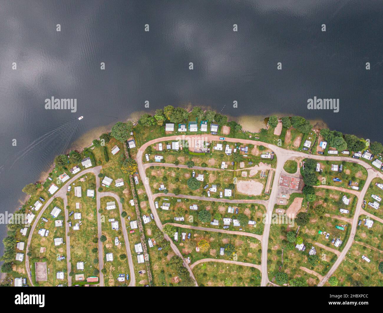 Aerial view of Longemer lake camping resort next to the lake water ...