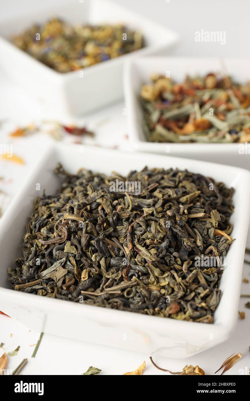 Concept of cooking tea with different types of tea on white background ...