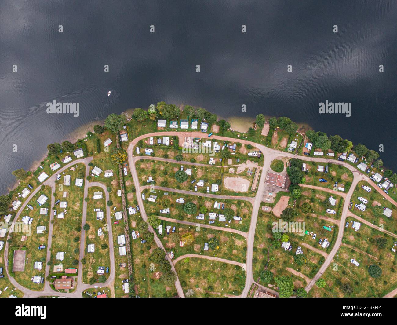 Aerial view of Longemer lake camping resort next to the lake water ...