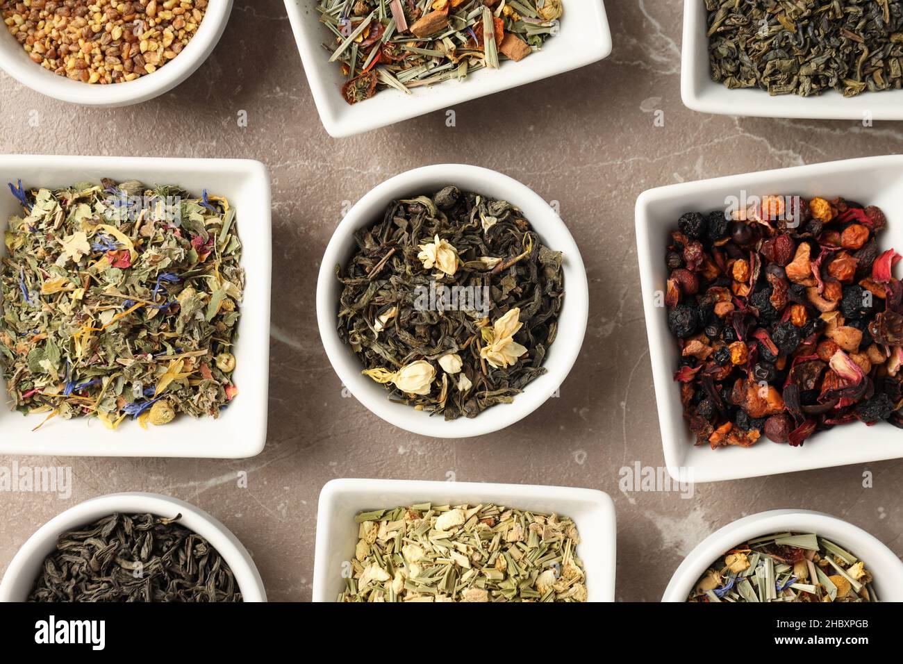 Flat lay with different types of tea on textured background Stock Photo ...
