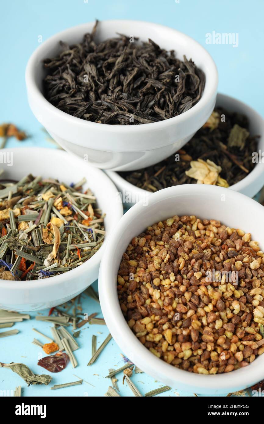 Concept of cooking tea with different types of tea on blue background ...