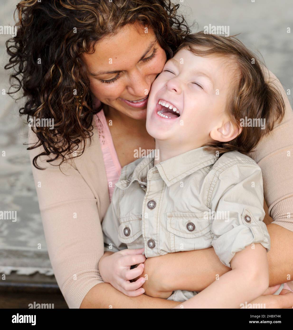 Woman hugging a boy, mother and sun laughing Stock Photo - Alamy