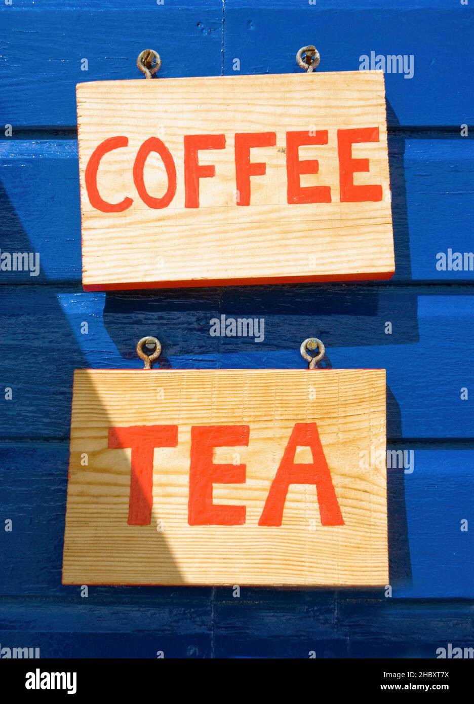 Coffee and tea signs on wooden wall or building exterior Stock Photo ...