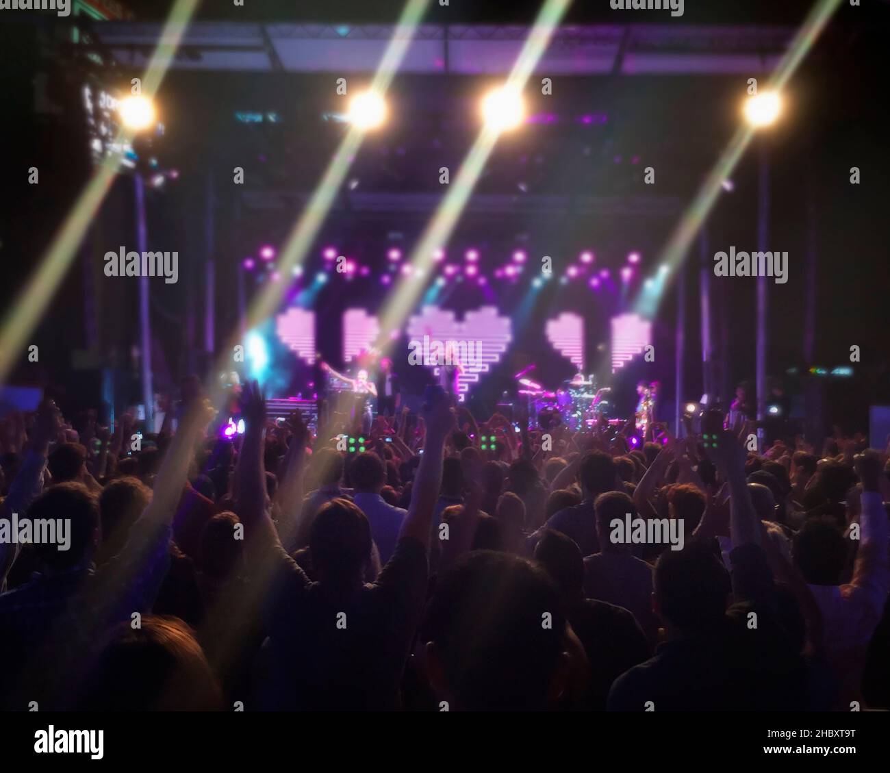 Concert goers watching performers on stage at music festival Stock ...
