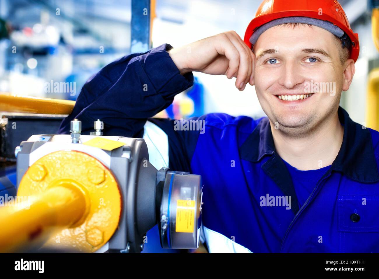 This is portrait of worker in helmet and clothes. Smiling engineer of ...