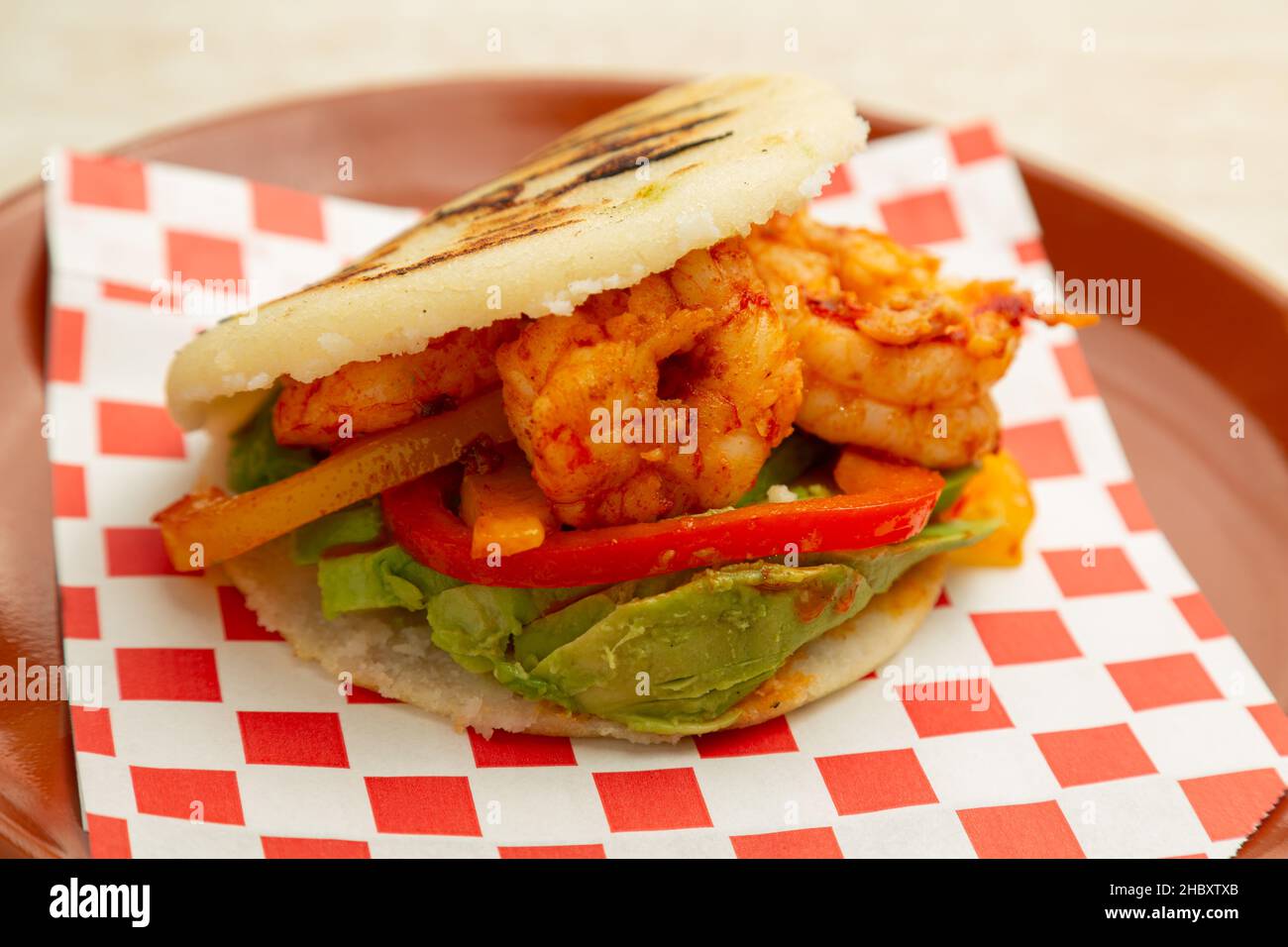 Latin American food Venezuelan Arepa with prawns and avocado Stock ...