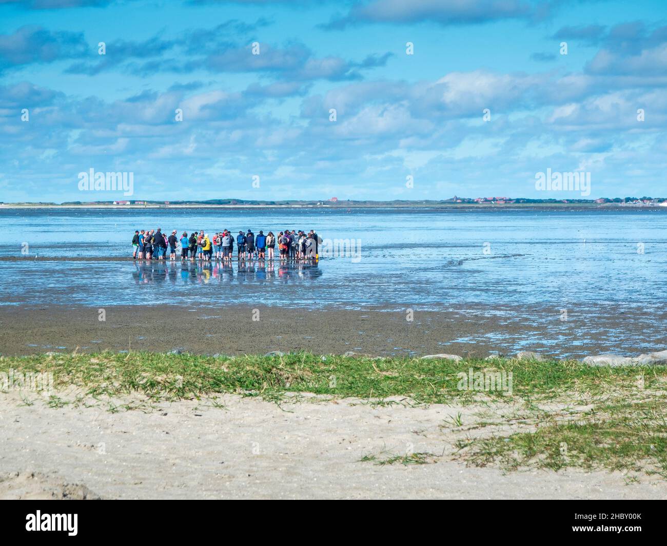 Landscape view of the North German Wadden Sea at low tide with a guided ...