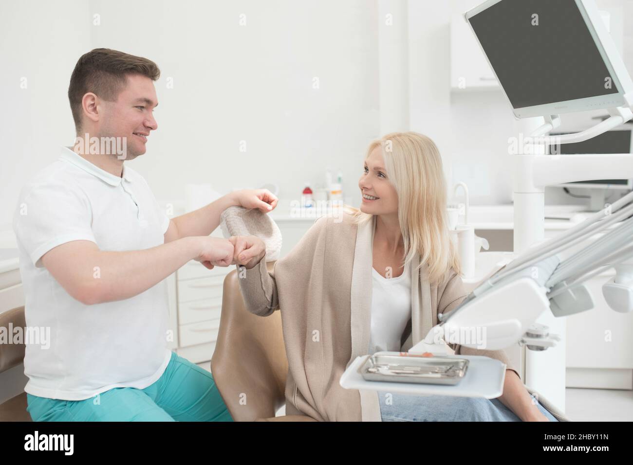Happy doctor and his patient after the dental surgery Stock Photo - Alamy