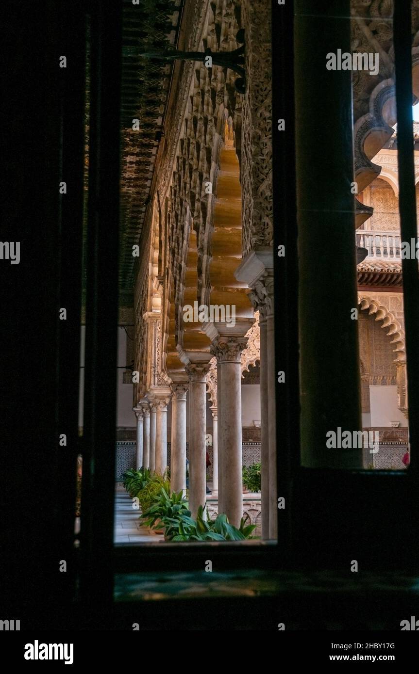 Multi-lobed Moorish arches lead to an open courtyard at the Alcázar of ...