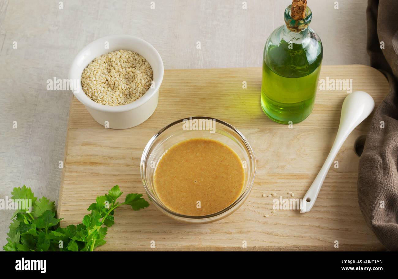 Ready sauce in a glass bowl with ingredients and herbs in your home ...