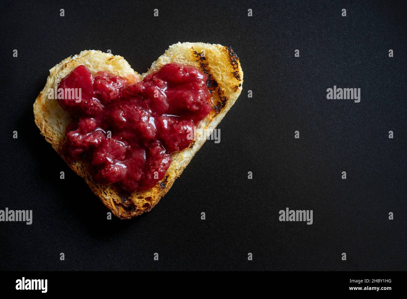 heart shaped toast with strawberry jam, isolated on black Stock Photo ...