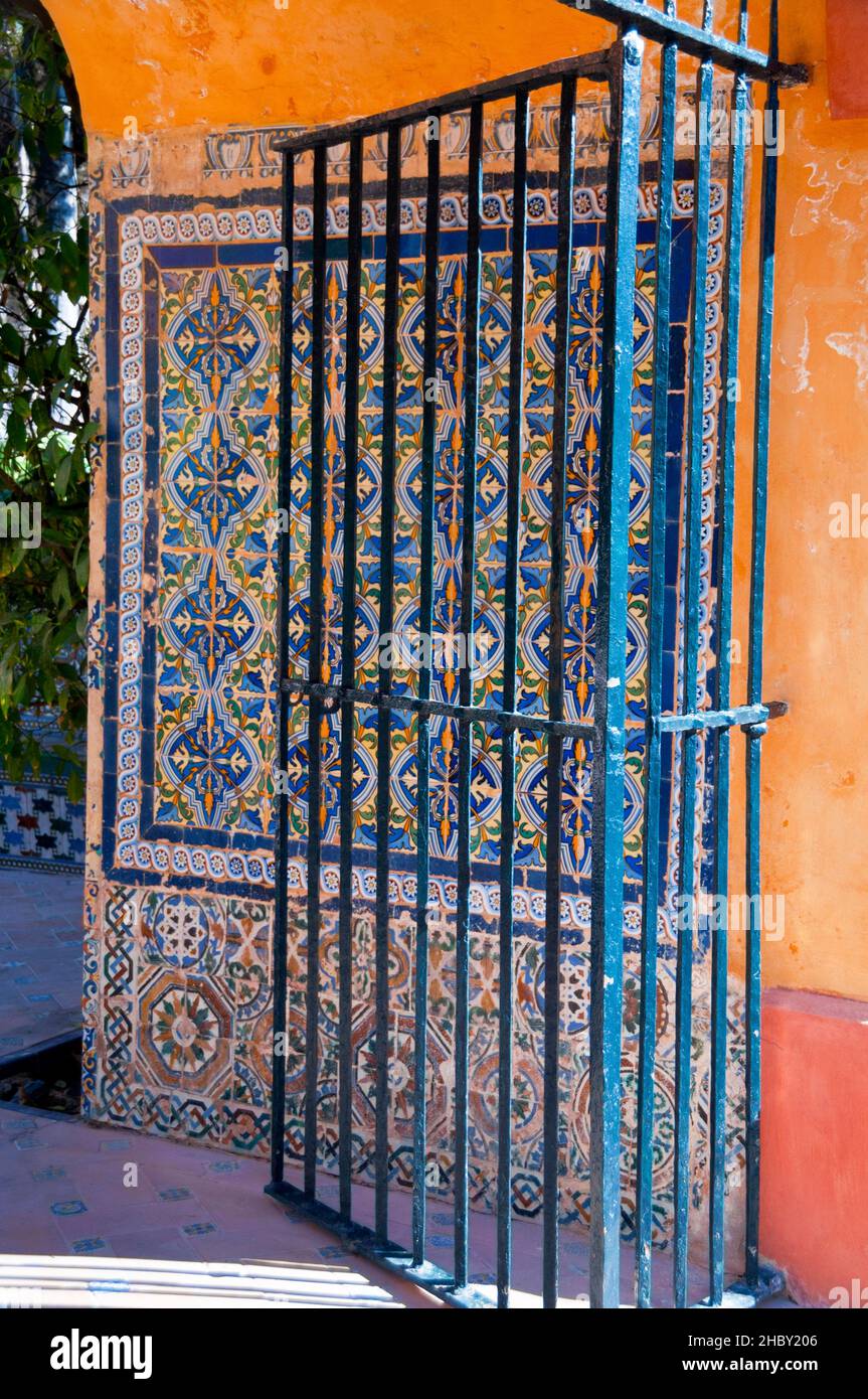 A colorful tiled barrel arched entrance to a garden in Seville, Spain ...