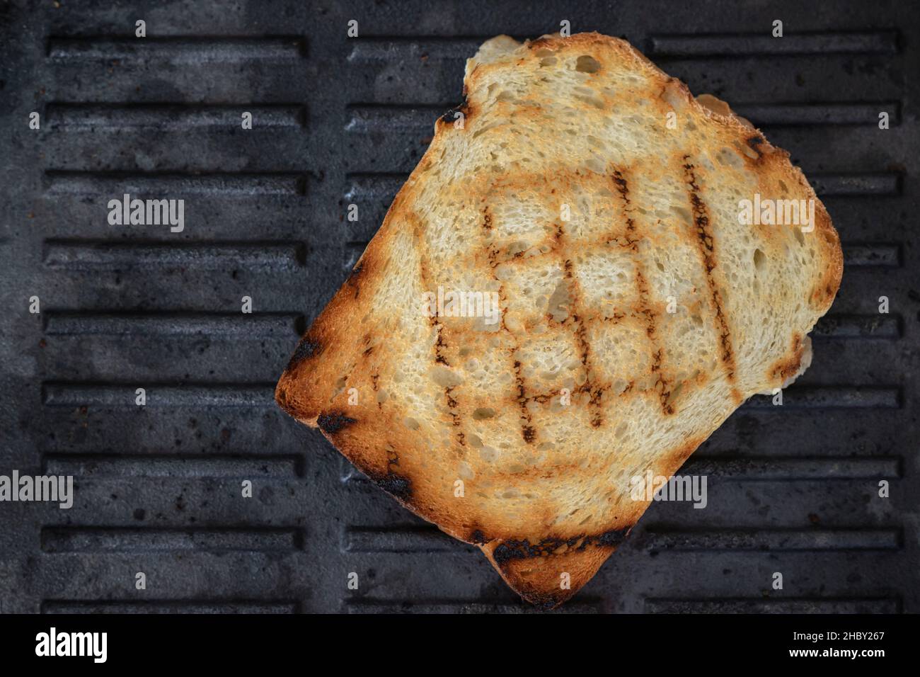 slice of bread with burn stripes on a cast iron grill Stock Photo - Alamy