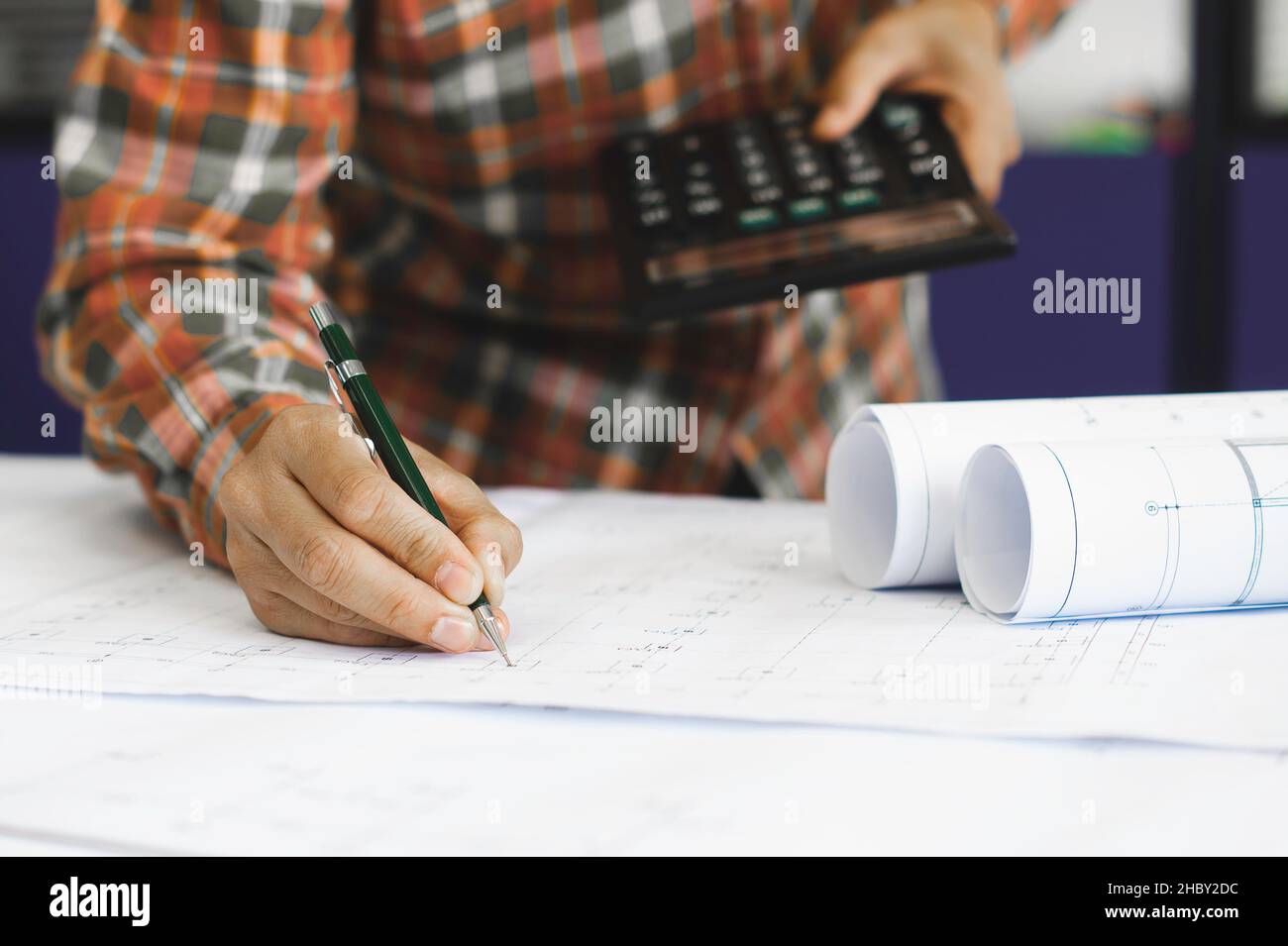 Focus on the technician's hand, an Asian engineer holding a pencil to ...