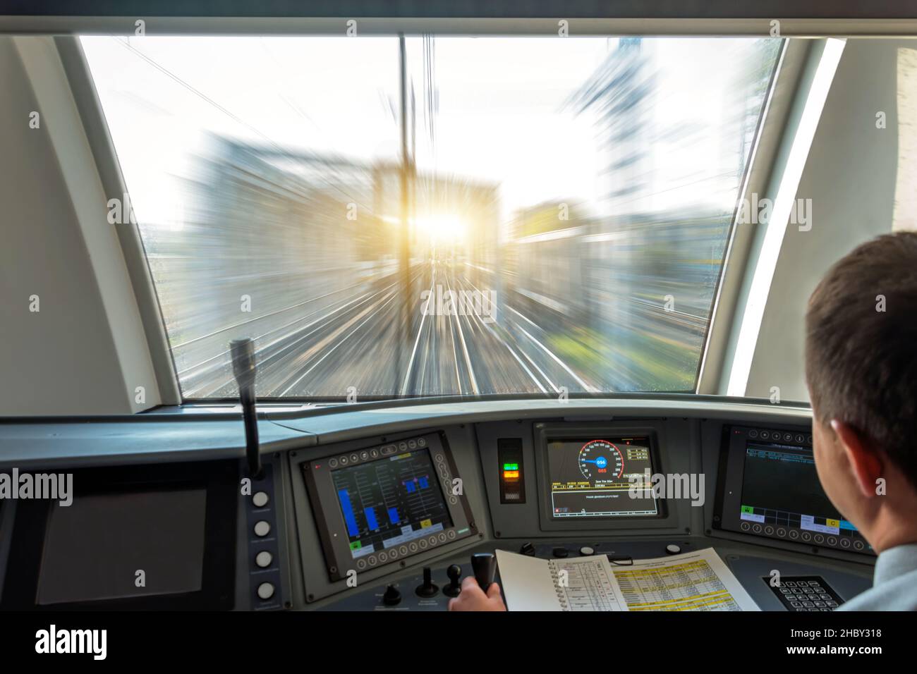 Train driver at the controls cab of speed passenger train, view of the ...