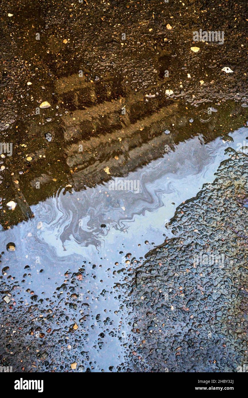 Beautiful abstract colorful background, engine oil stains on asphalt ...