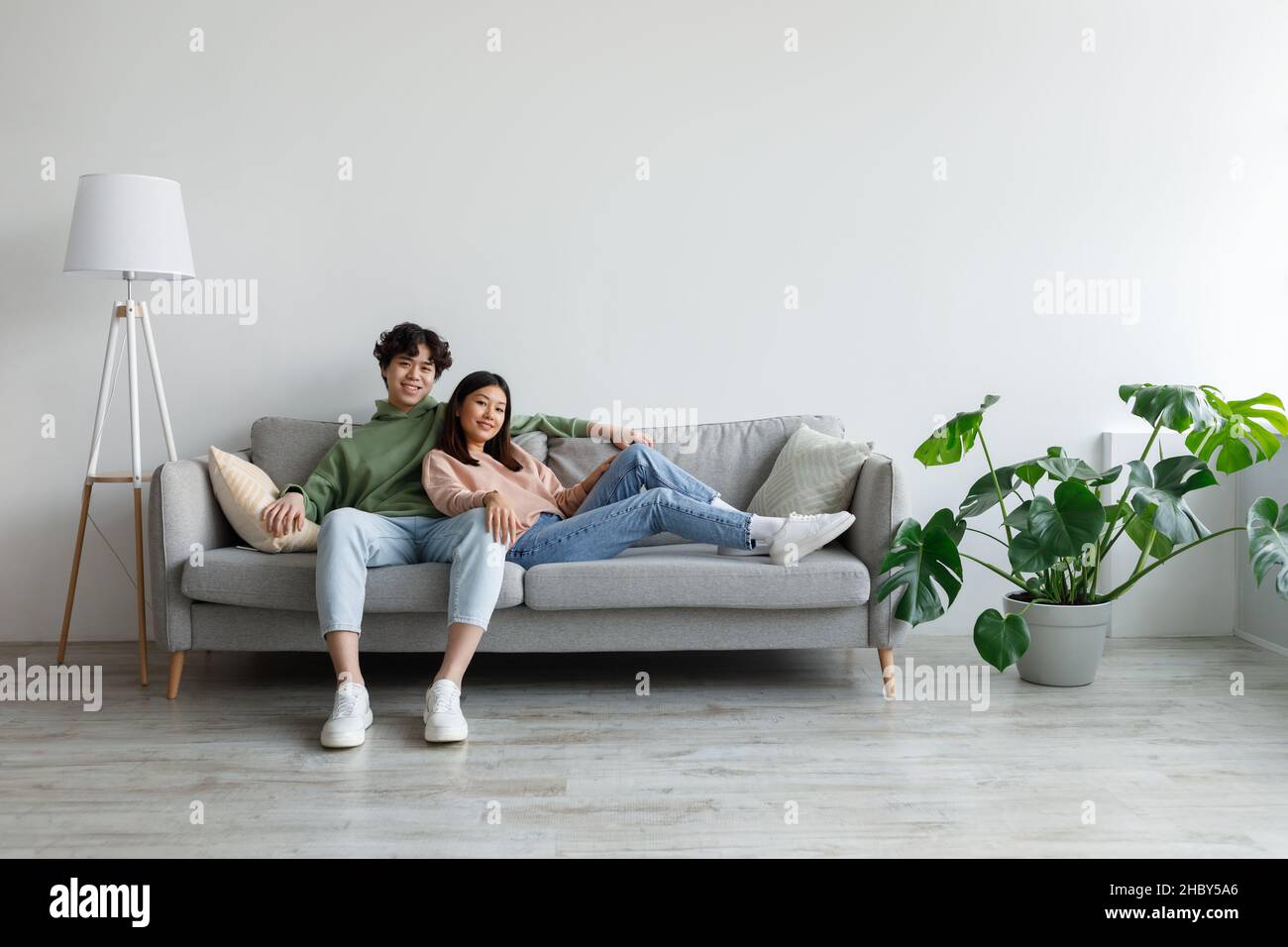 Couple cuddling on couch hi-res stock photography and images - Alamy