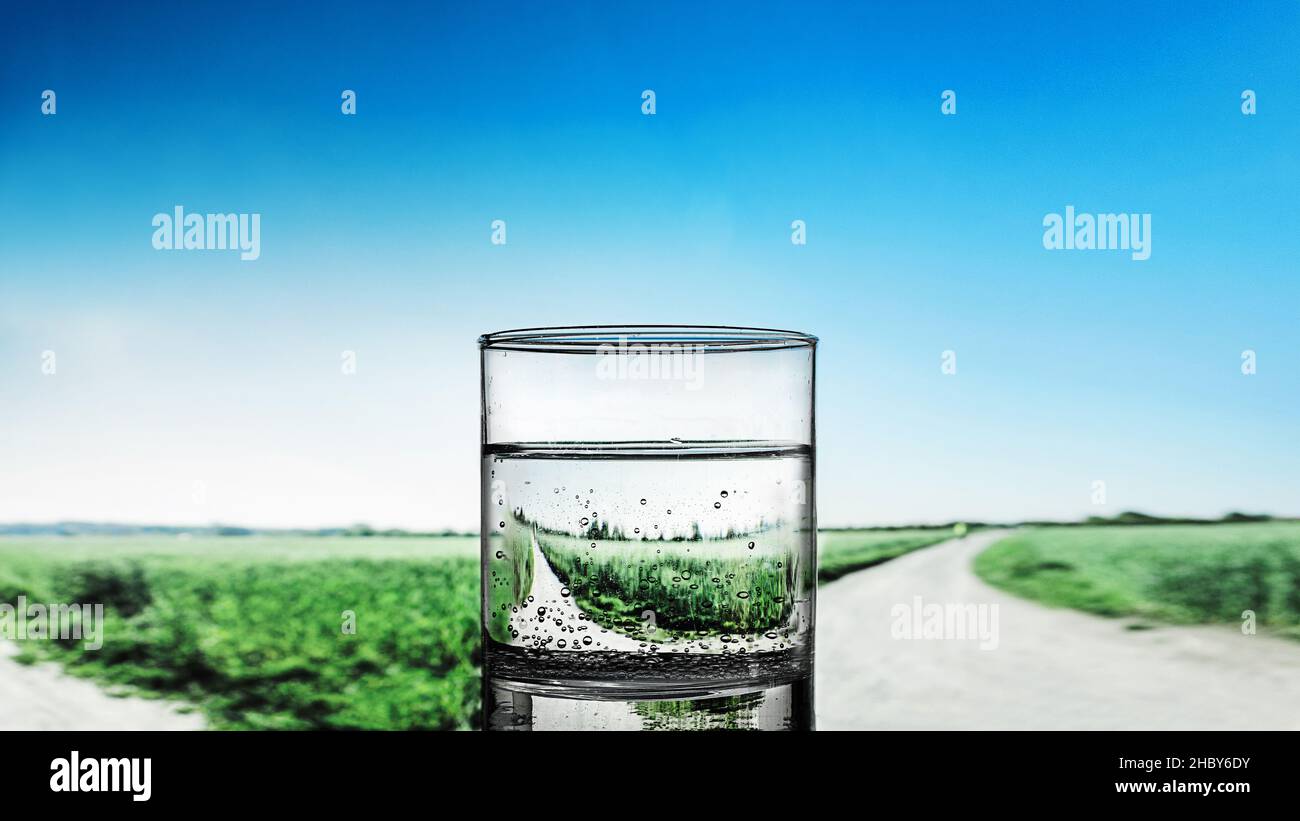 A view of the glass of water on the nature background Stock Photo - Alamy
