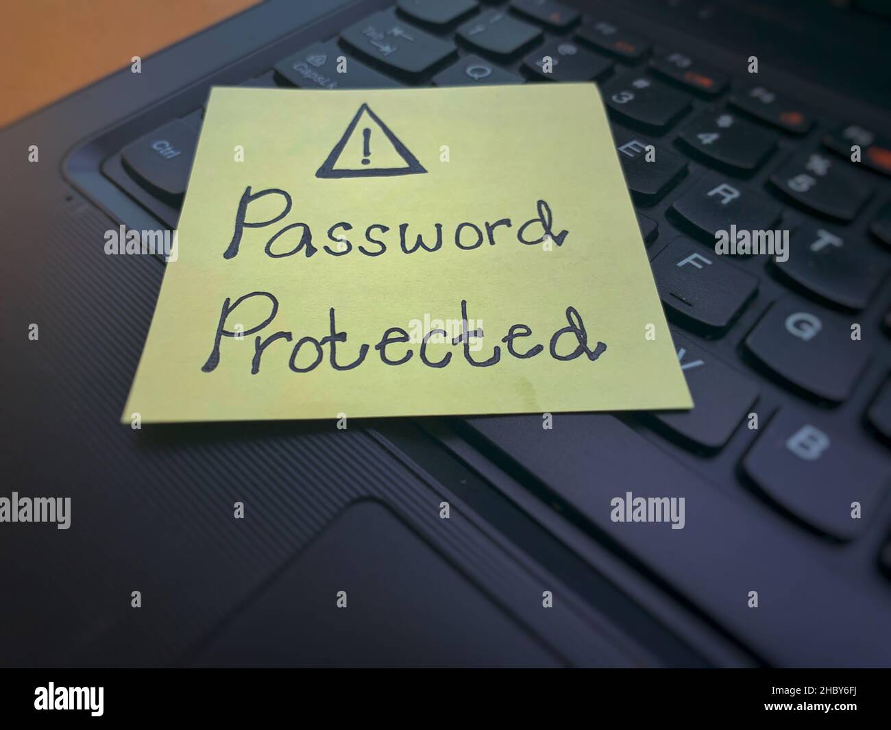 Password Protected Text Written On Sticky Note On Top Of A Blurred