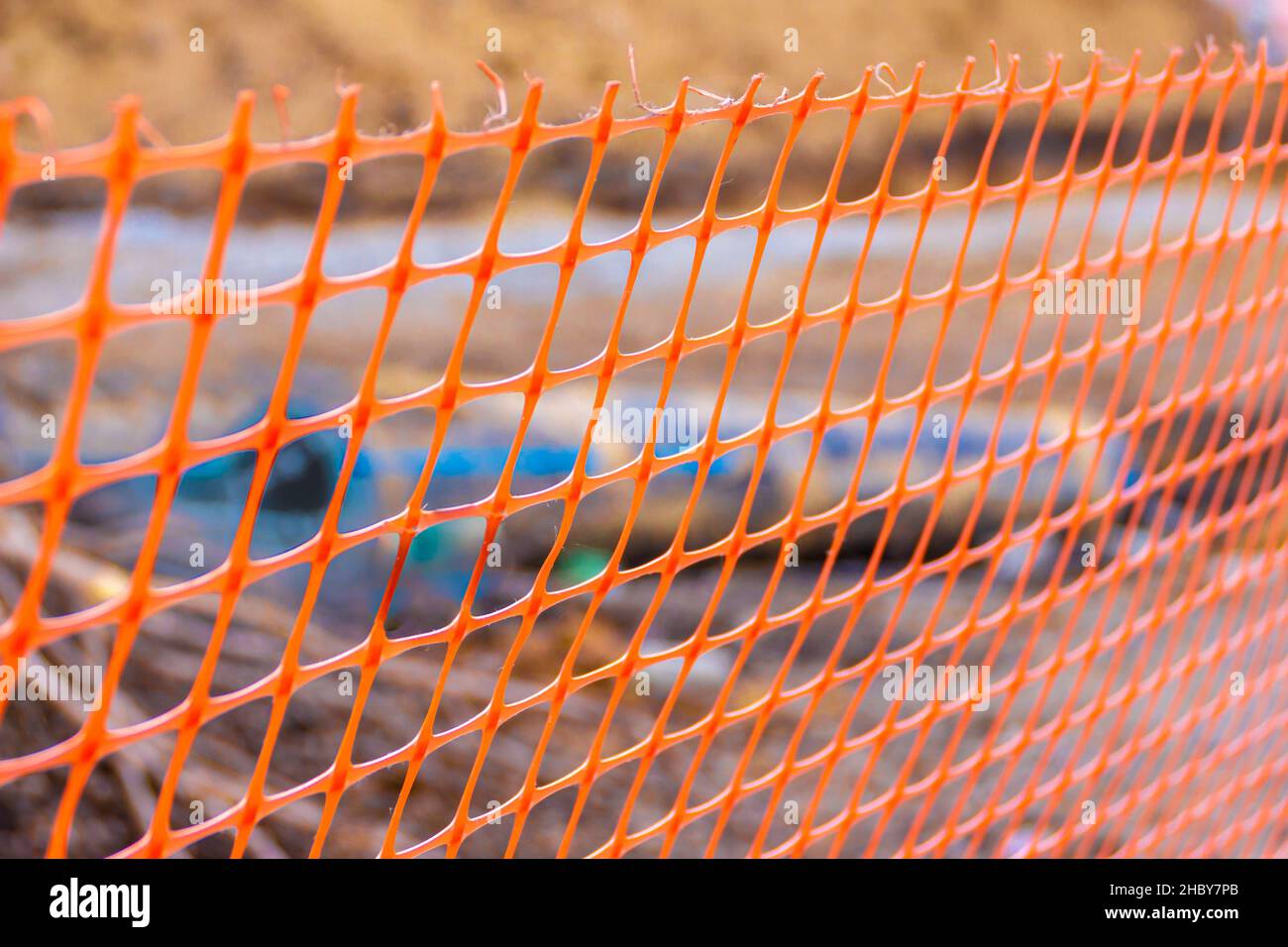trench fenced with bright emergency orange mesh for safe excavation ...