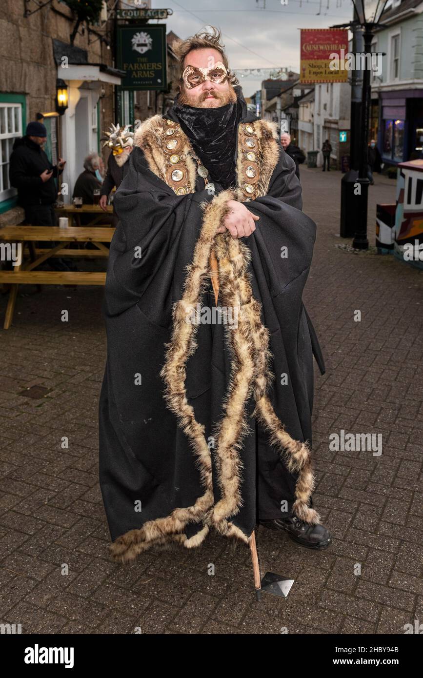 A masked participant in the Montol Festival parade; in Penzance in ...