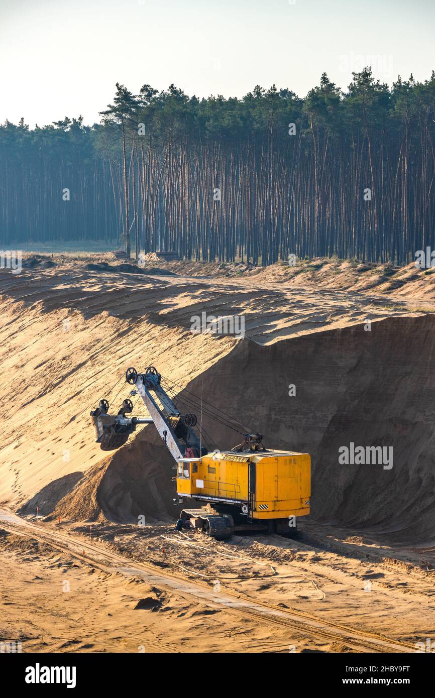 Heavy excavator in sand quarry, sand mining industry Stock Photo - Alamy