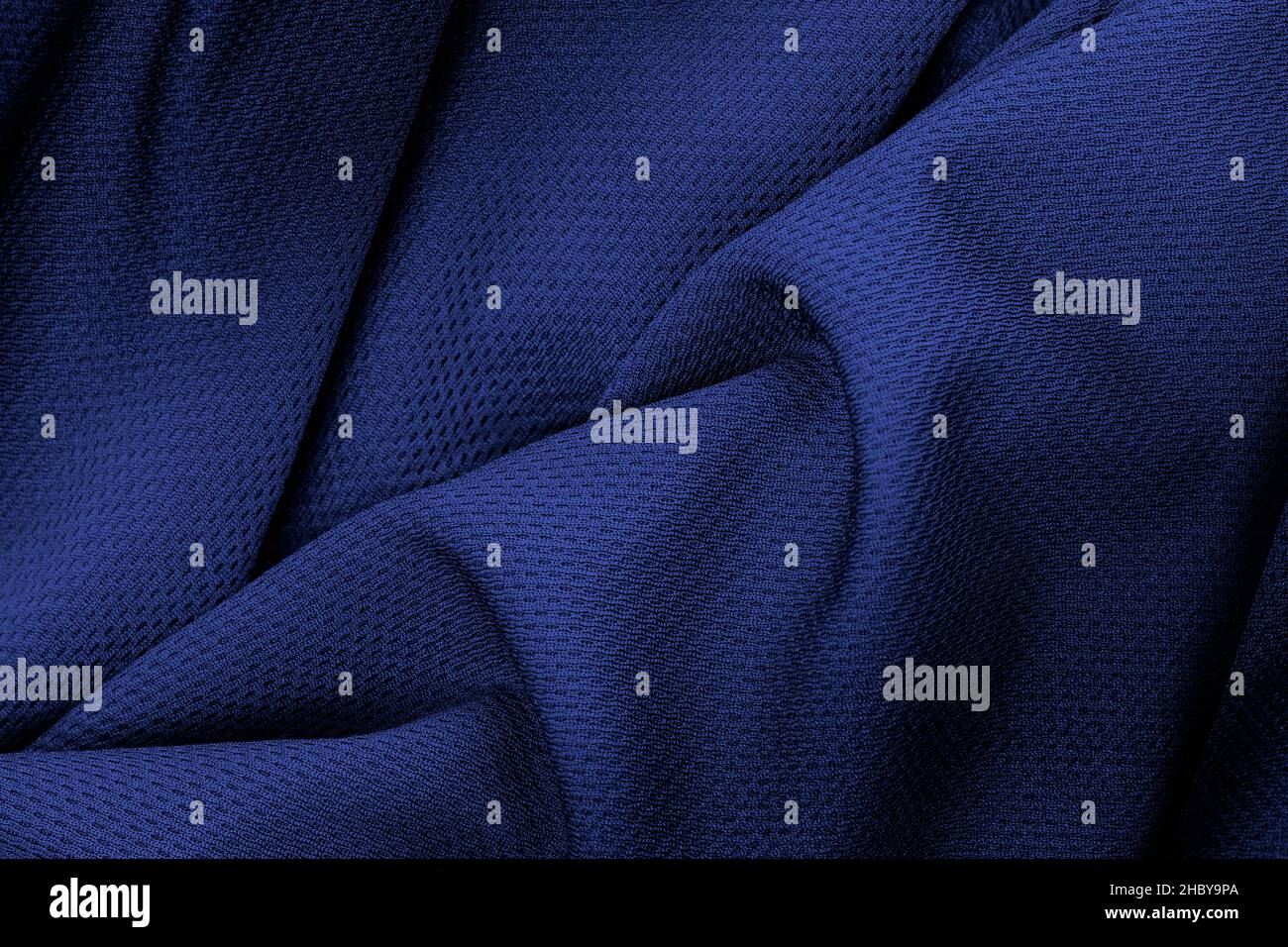 Close up view of royal blue color folded linen fabric cloth for texture ...