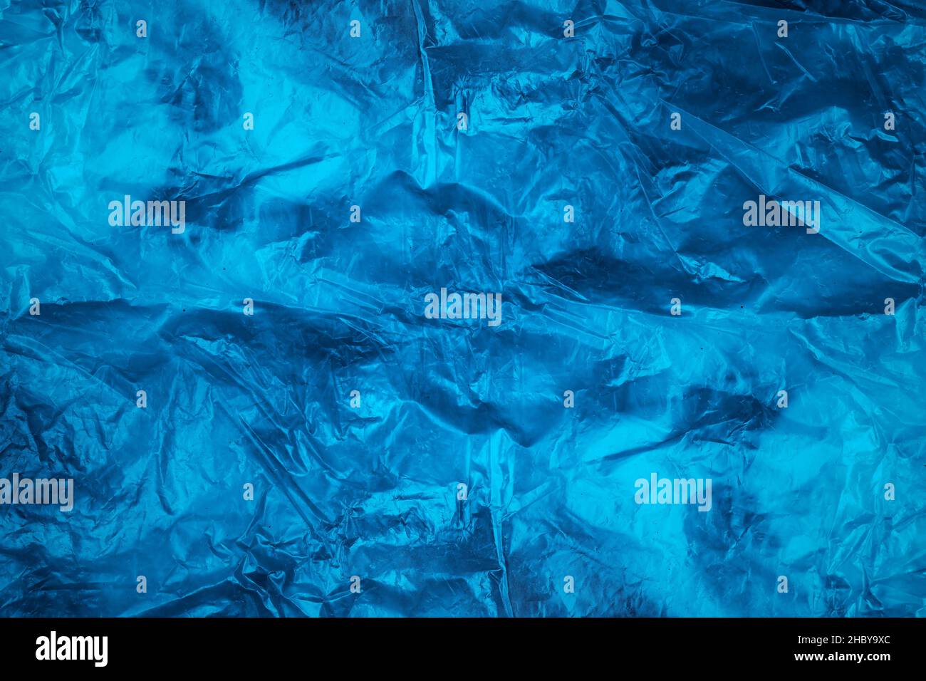 Used blue color wrapped shiny polythene texture for background Stock ...