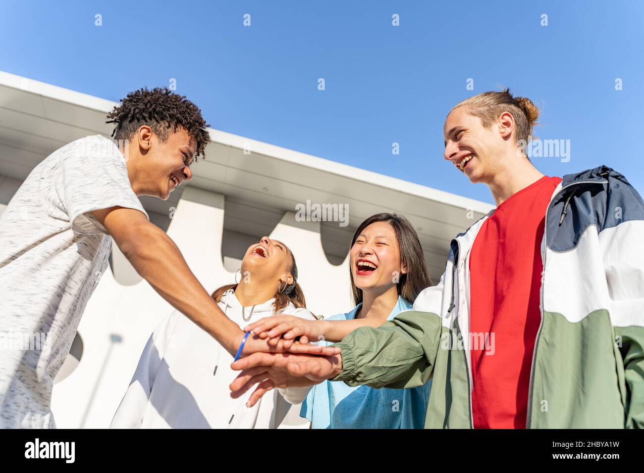 College student teamwork stacking diverse hand togetherness concept ...