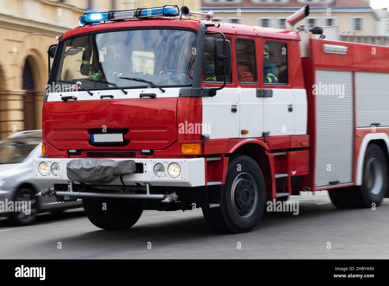 Fire truck in city. Firefighters on the way to rescue Stock Photo - Alamy