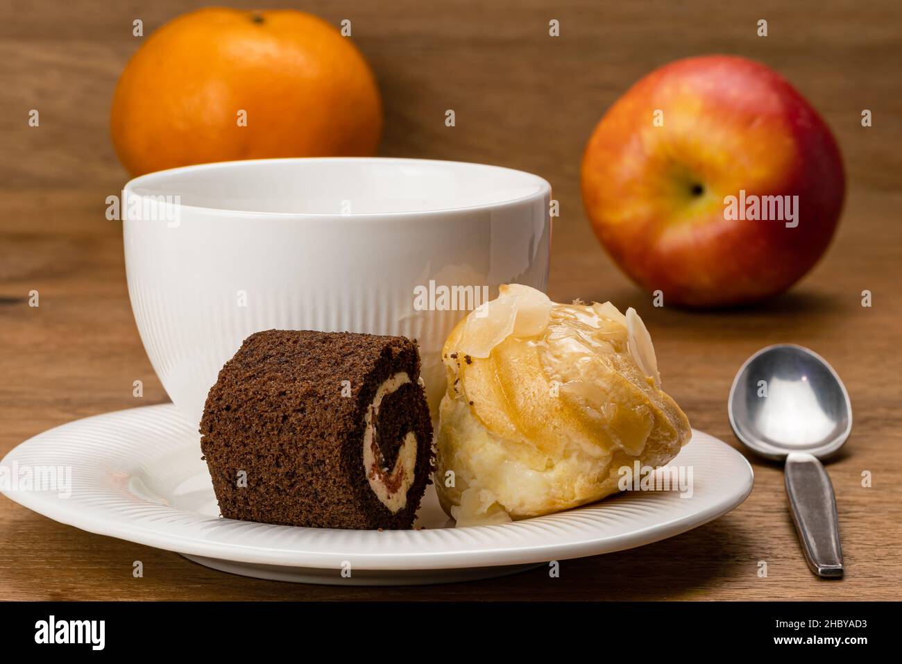 Delicious breakfast with Sweet Chocolate Roll, Eclair filled with sweet ...
