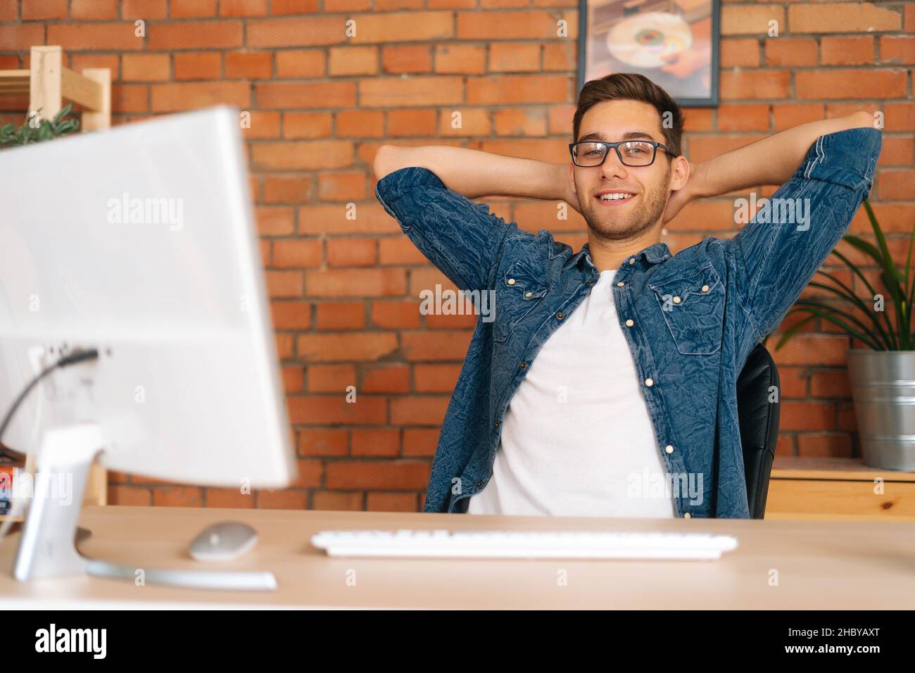 Portrait of satisfied handsome young freelance programmer male in ...