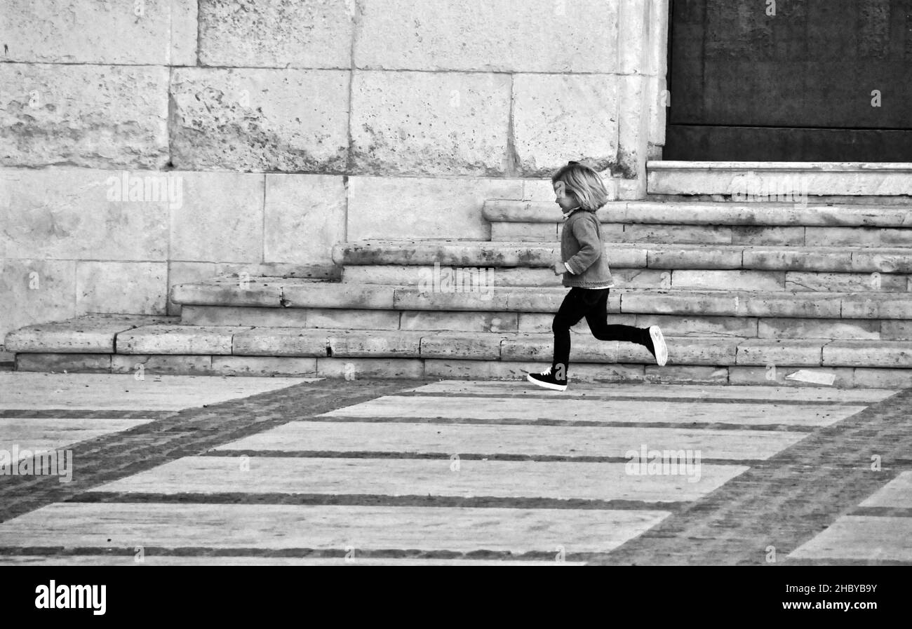 Girl running in front of steps of a church, black and white photo ...